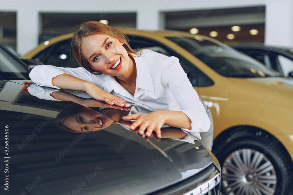 Beautiful young woman touching her new car with pleasure Stock Photo ...