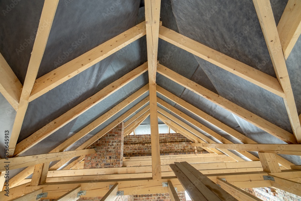 Attic space of a building under construction with wooden beams of a ...