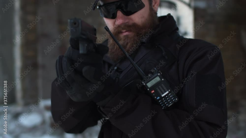 Video Stock Slow-motion dolly shot of bodyguard, security guard draw ...