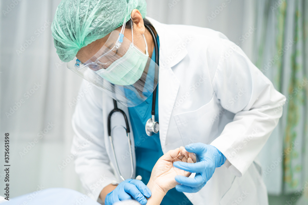 Asian doctor wearing face shield and PPE suit new normal to check ...