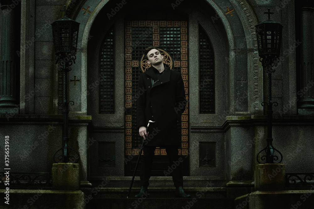 Young elegant vampire in front of a mausoleum Stock Photo | Adobe Stock