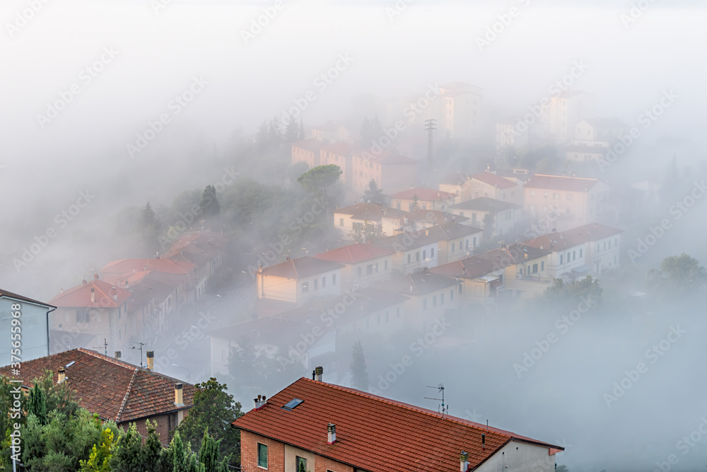 Foreground of roof in Chiusi Scalo town village cityscape fog sunrise ...