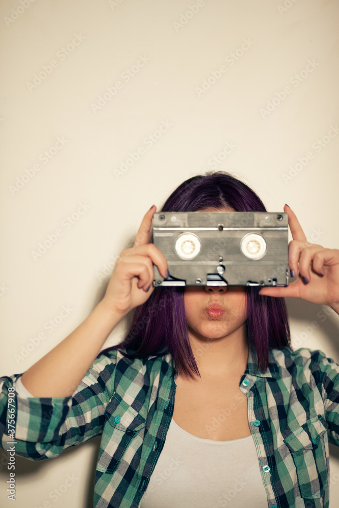Retro Girl holding VHS cassette Stock Photo | Adobe Stock