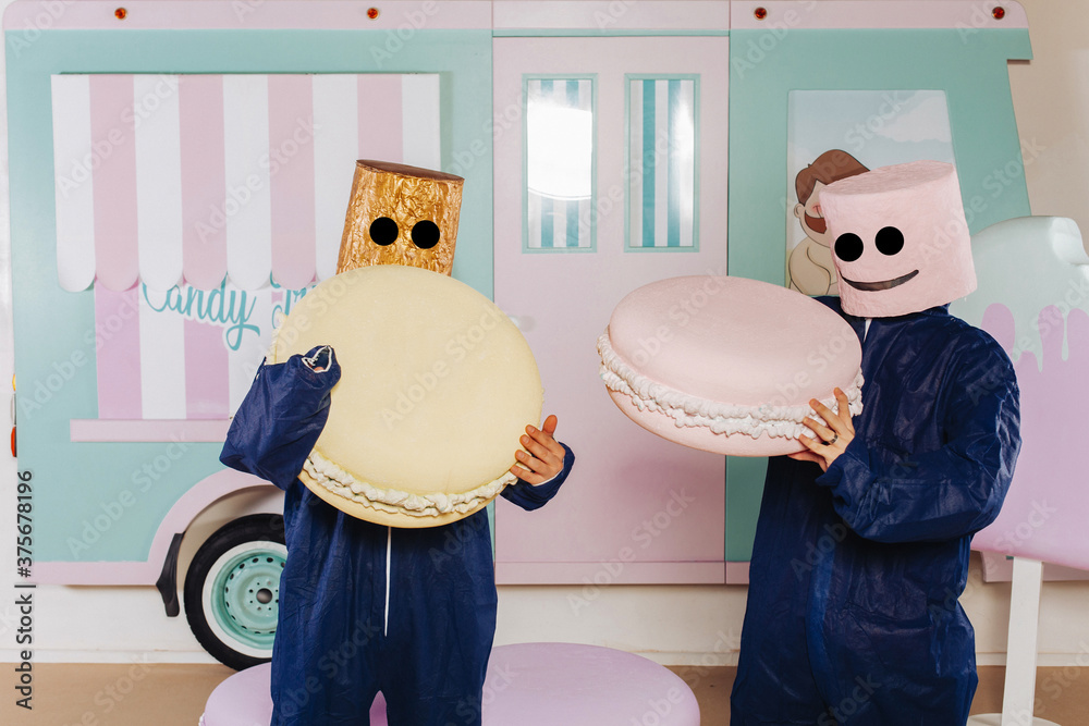 People in a suit of a man-marshmallow on the background of an ice cream ...