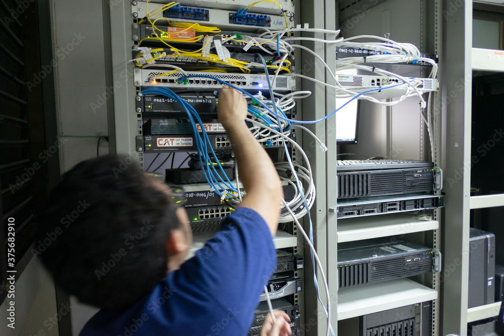 The system administrator works in the server room of the data center ...