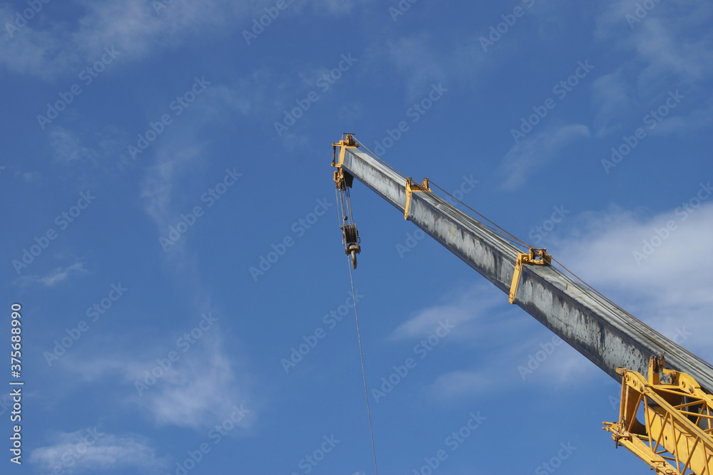 Yellow Telescopic Arm of a Mobile Crane Operating at a Construction ...