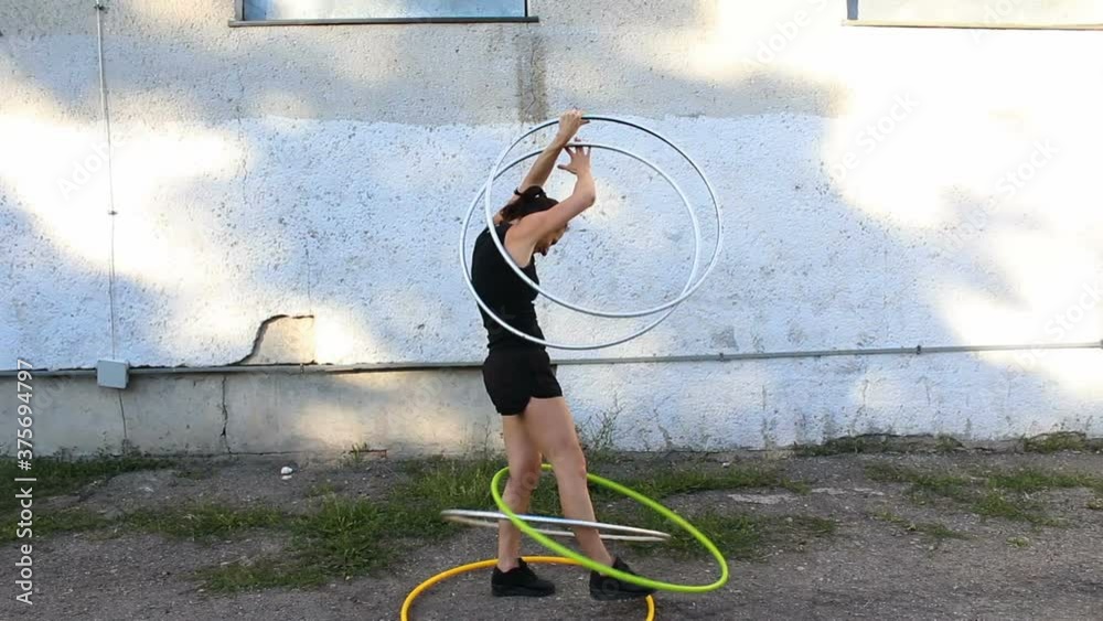 Street Performer Practices Hula Hoop Spinning Skills. An attractive ...
