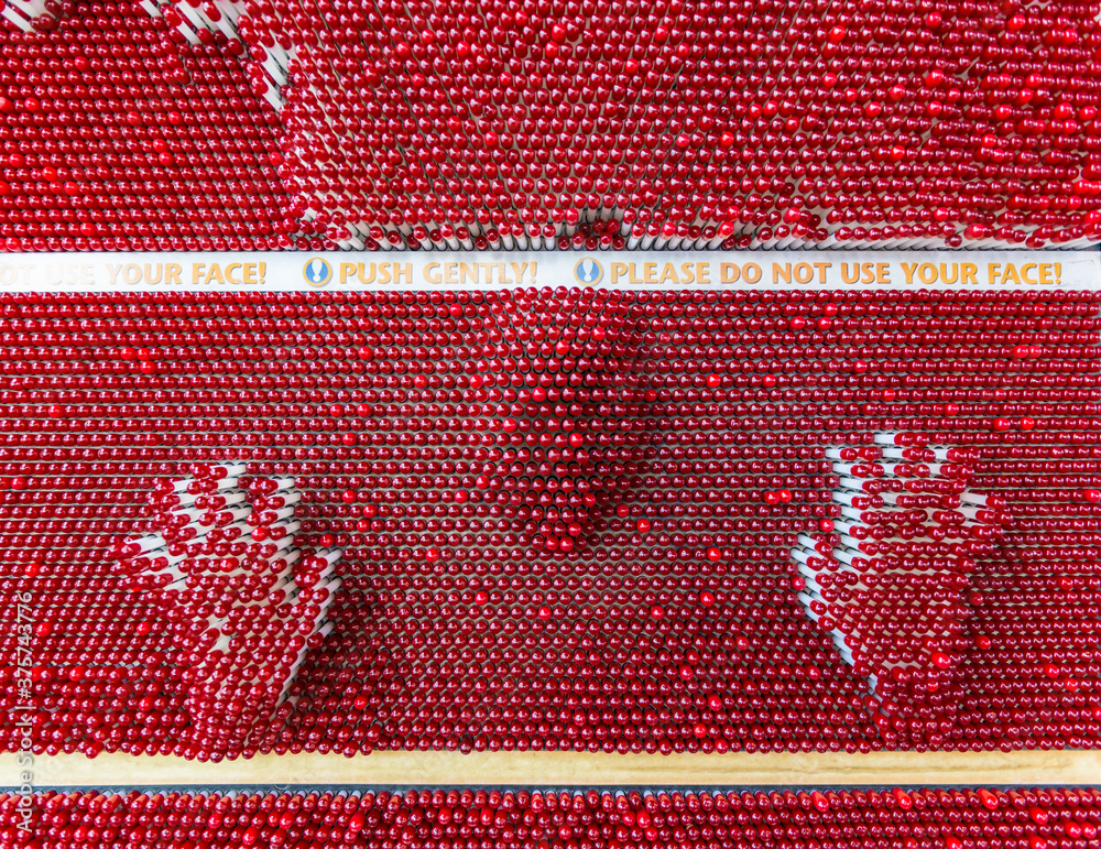 Child Uses Hands and Face To Create Shape in Push Pins Stock Photo ...