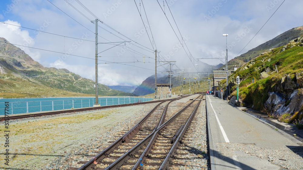 Bernina pass, Switzerland. The red train tracks at the Ospizio Bernina ...