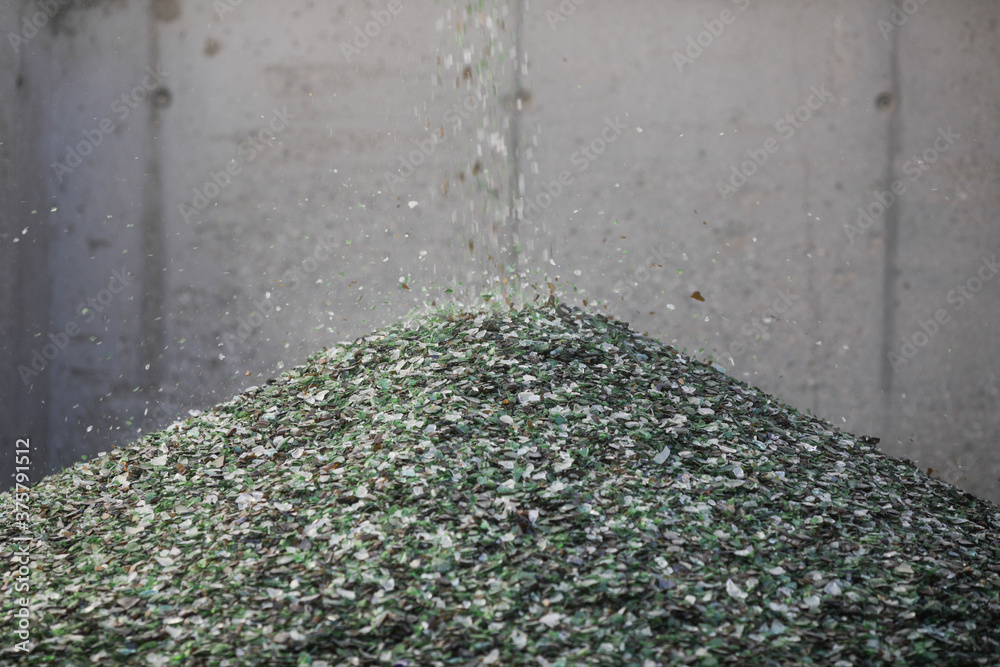 Details with shards of glass falling from a conveyor belt on a pile in ...
