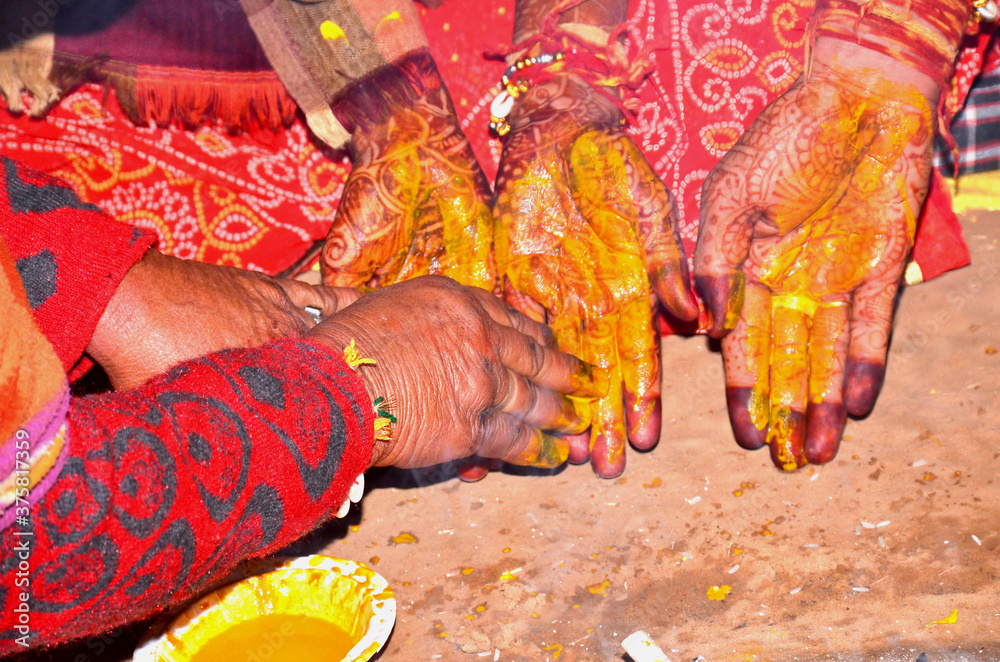 Closeup of Indian bridal haldi and mehndi henna hand, pasting turmeric ...