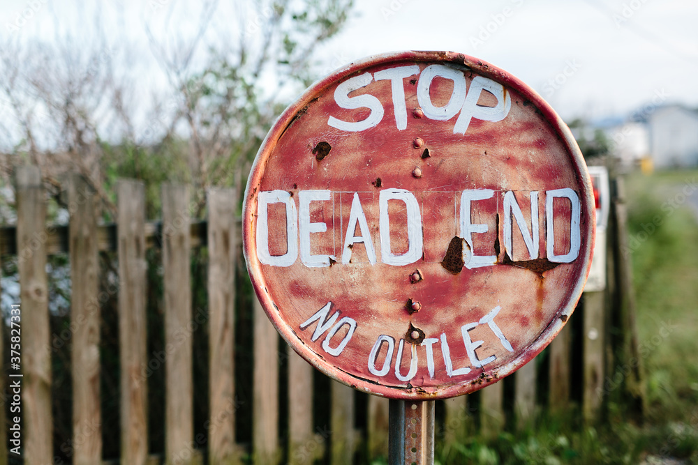 No outlet dead end stop sign on post at end of road Stock Photo | Adobe ...