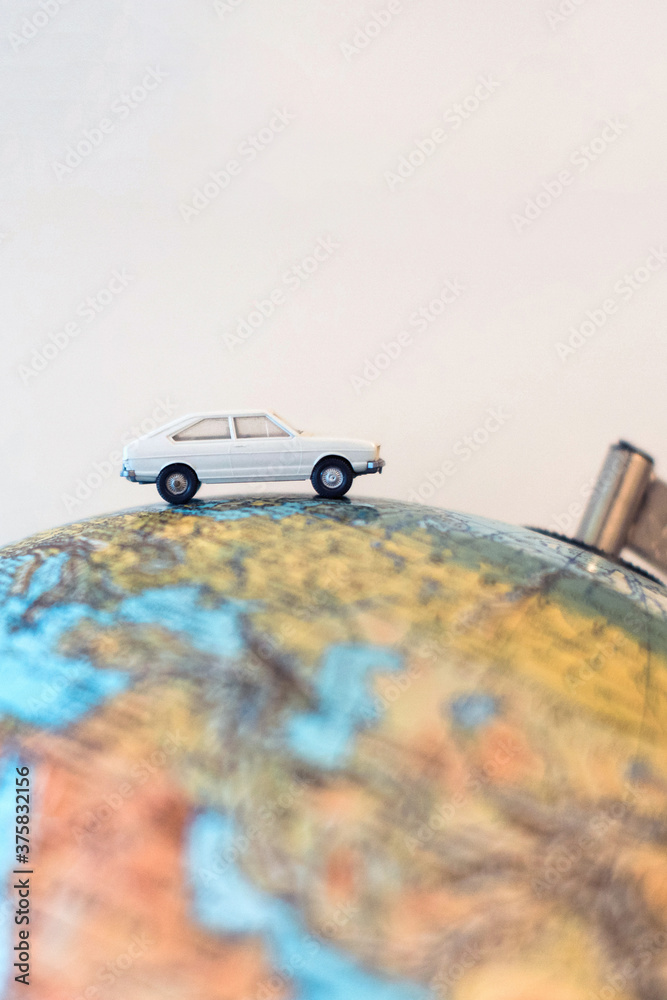 Toy car on a world map globe Stock Photo | Adobe Stock