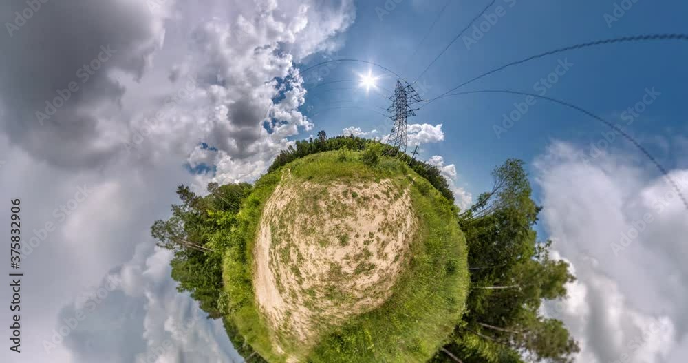 green little planet revolves among clear blue sky and white clouds in ...