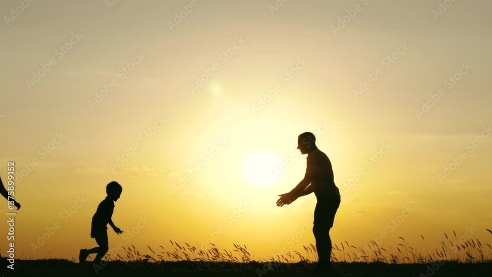 A little boy runs to his father. A happy father throws the child up ...