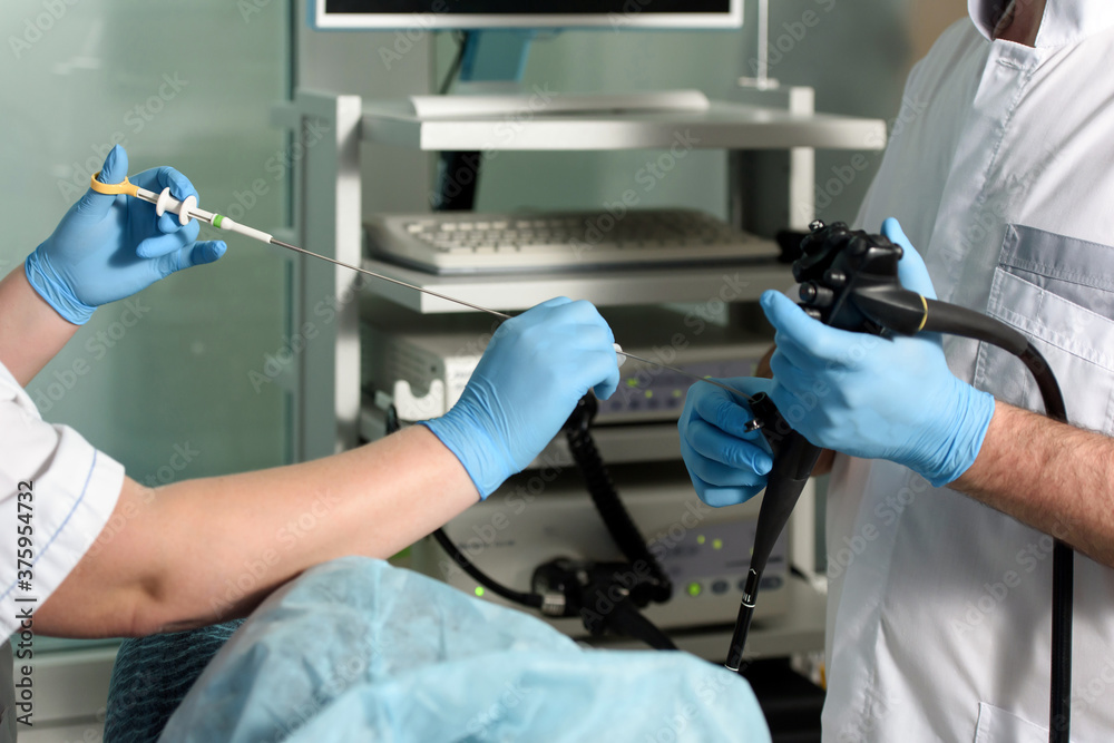 Endoscopic examination. The doctor holds an endoscope in his hand ...