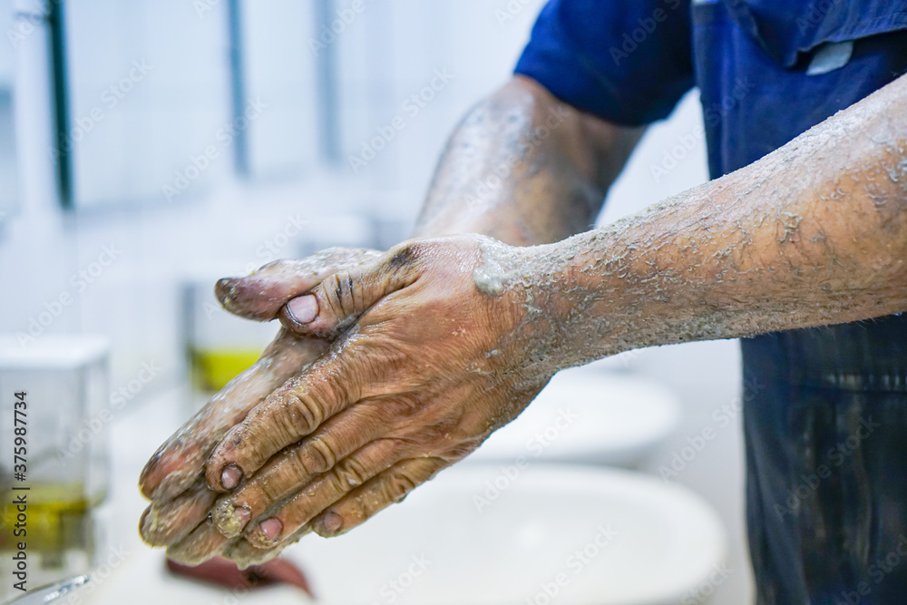 the mechanic washes his dirty hands after a working day Stock Photo ...