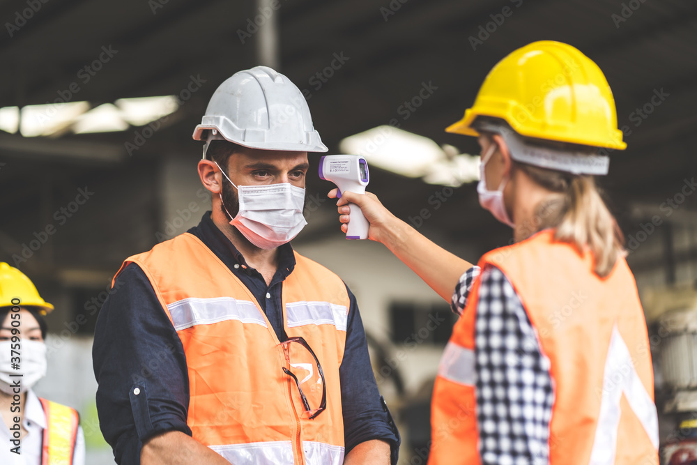 Temperature measurement with employee temperature meter before entering ...