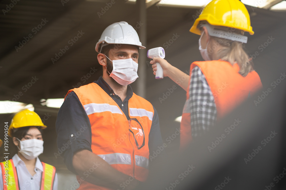 Temperature measurement with employee temperature meter before entering ...