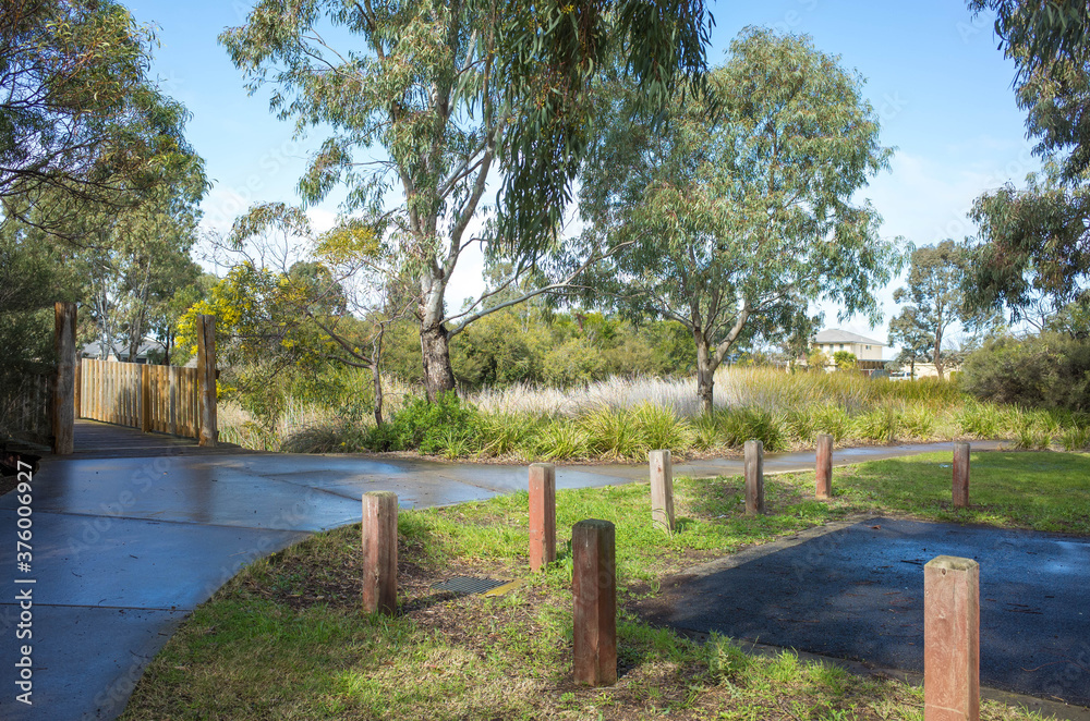 Pedestrian walkway/footpath around wetlands with native plants in an ...