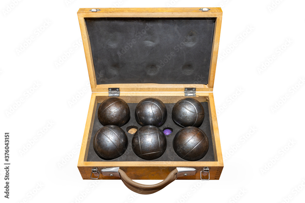 Six metal balls placed in a old wooden box, used in game petanka ...