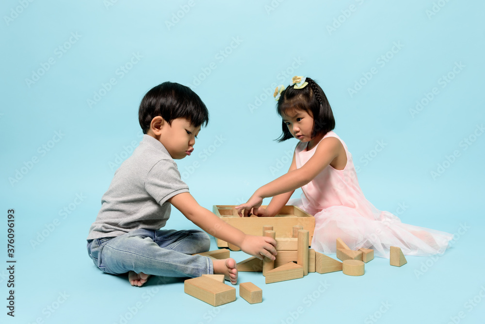Asian two people kids playing together to be enjoyable with wooden toys ...