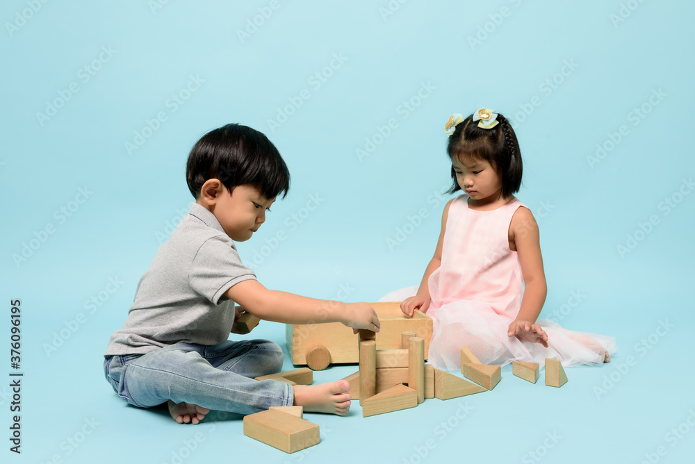 Asian two people kids playing together to be enjoyable with wooden toys ...