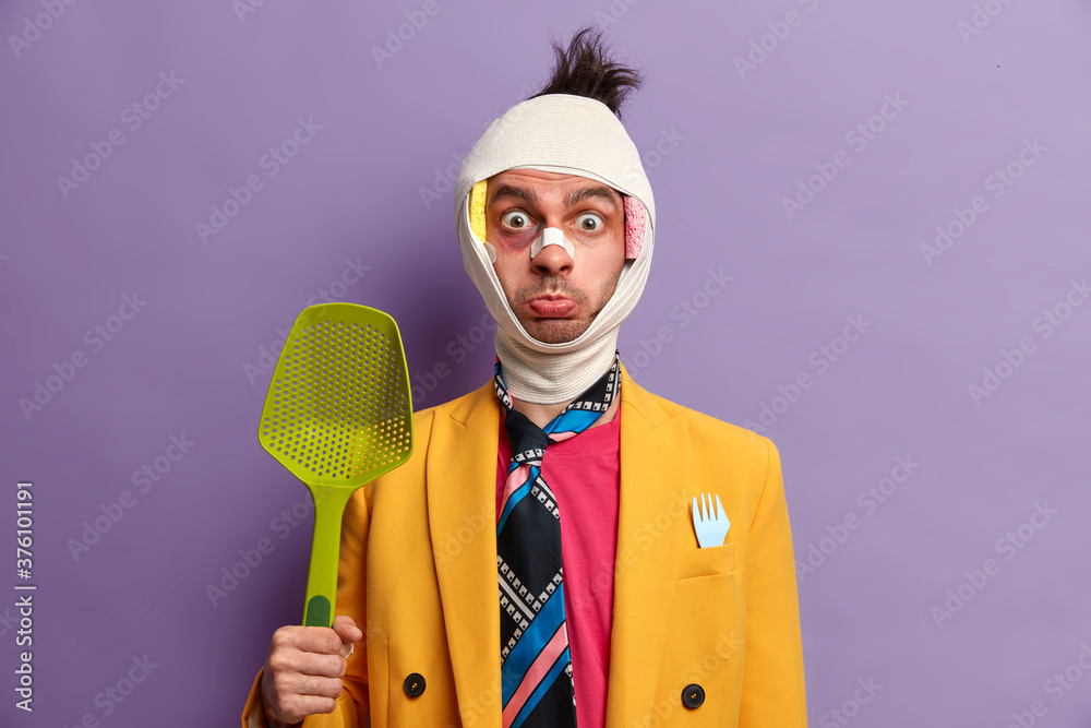 Dejected sad man has problems with health, stares surprised at camera ...