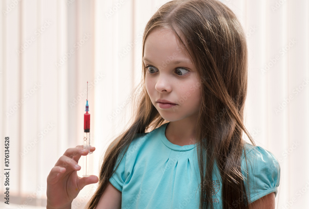 Kid and injection syringe. Child girl with vaccine, vitamin, medicine ...