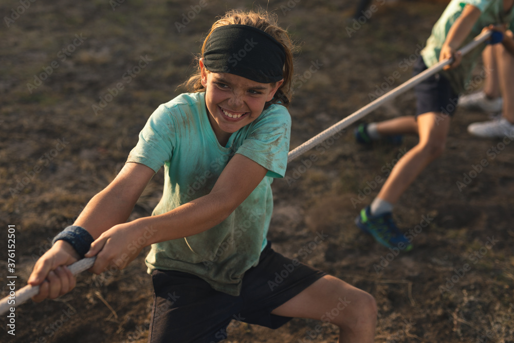 Girl pulling rope at boot camp Stock Photo | Adobe Stock