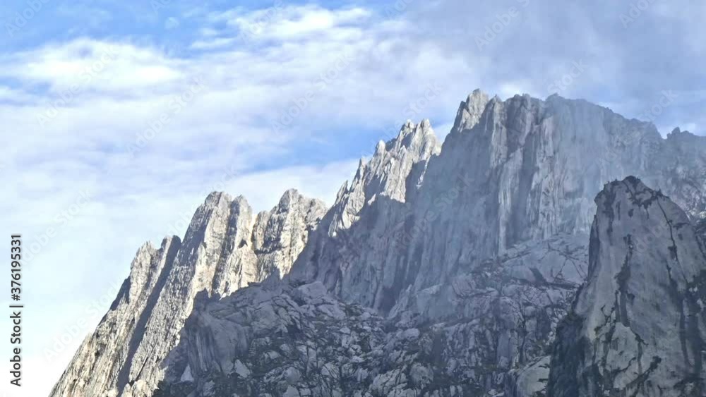 Time-lapse of beautiful mountain with clouds moving, in the bright ...