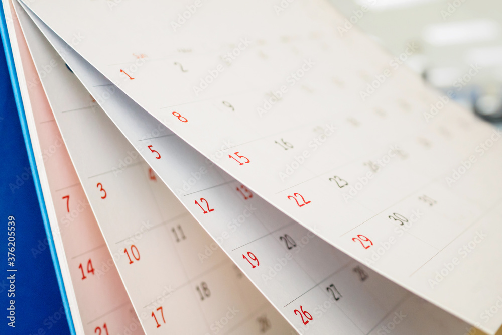 Calendar page flipping sheet close up on office table interior ...