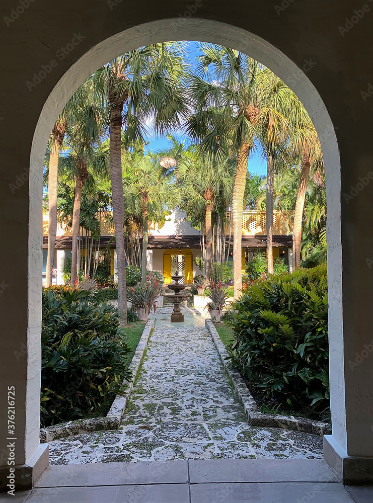 View of the Bonnet House courtyard as seen through an arch doorway. The ...