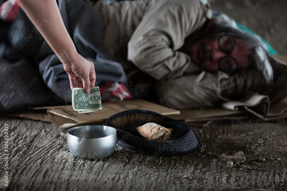 Hand of people giving the money for homeless man while his sleeping on ...