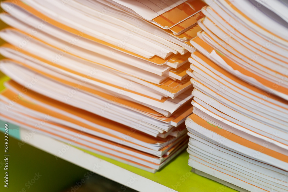 Pile of stack orange student homework book of high school students on ...