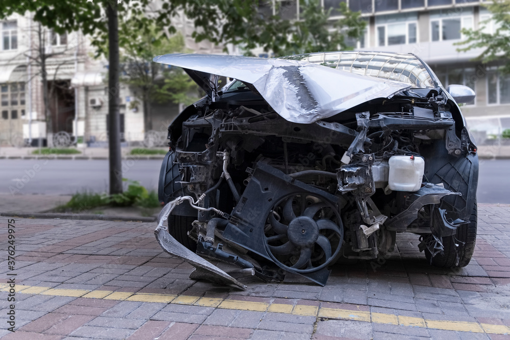 Car crush. Close-up front view of a wrecked car. Car after head-on ...