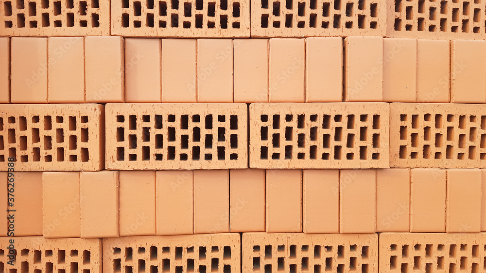 Red brick background with holes. Red perforated brick with rectangular ...