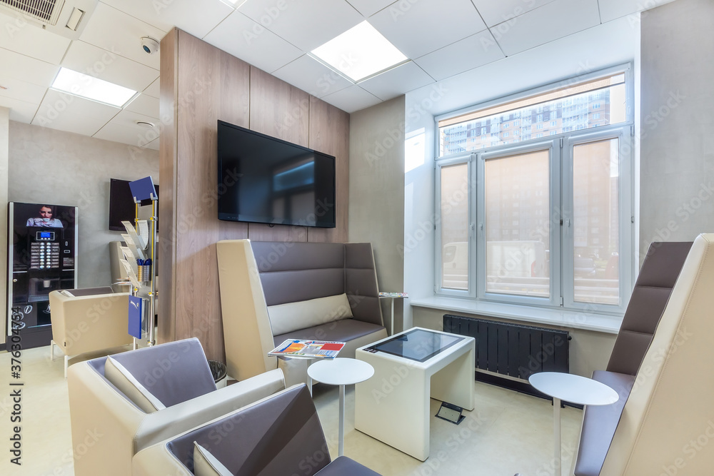 The waiting area in a modern sales office with a vending coffee machine ...