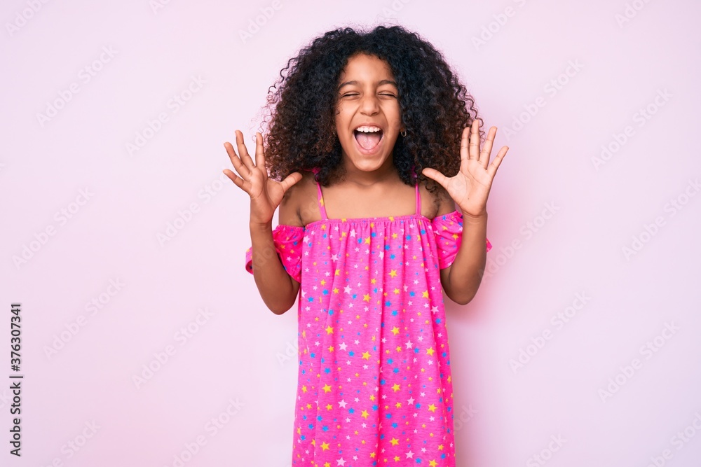 African american child with curly hair wearing casual dress celebrating ...
