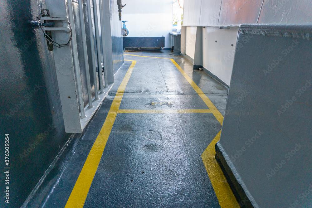 Safety walkway on ships deck. Yellow line walkway. Guided walkway on ...