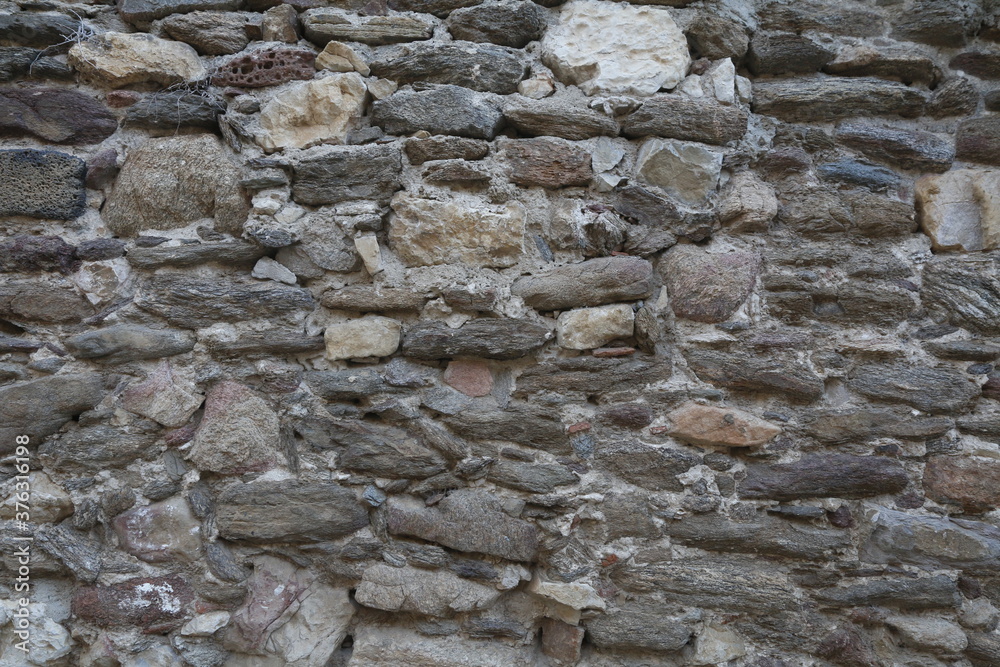 texture di un muro di sassi colorati e cementati Photos | Adobe Stock