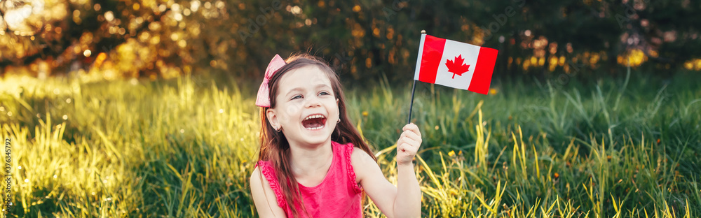 Happy Caucasian girl holding Canadian flag. Smiling child holding ...