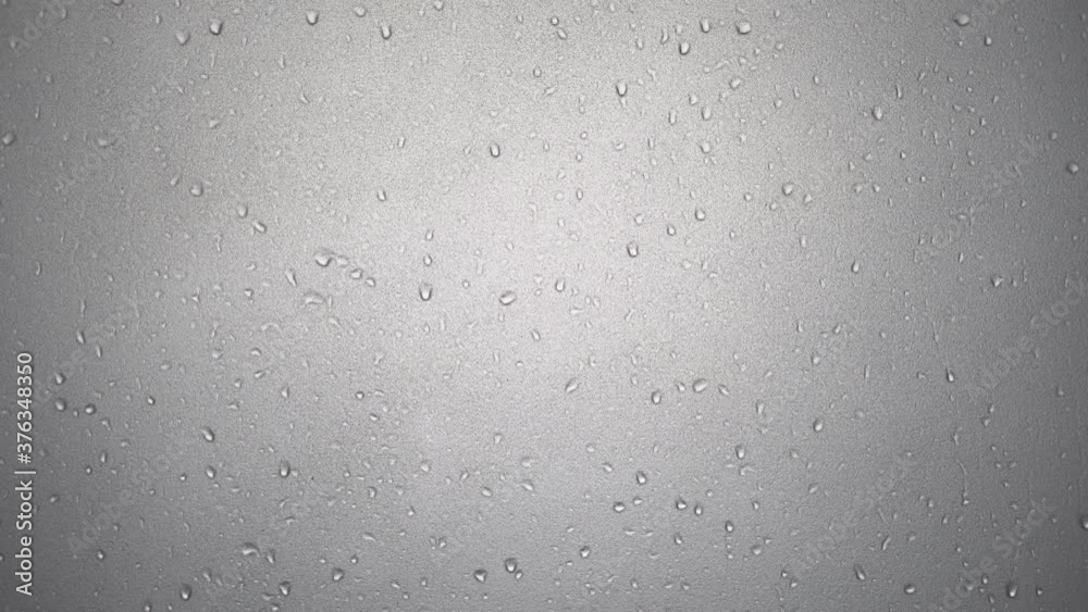 Water droplet on frosted glass wall or wet translucent window by shower ...