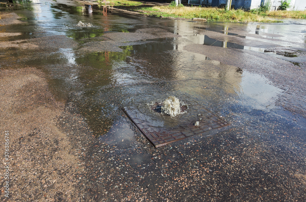 Water flows out of drainage hatch. Drainage fountain of sewage ...