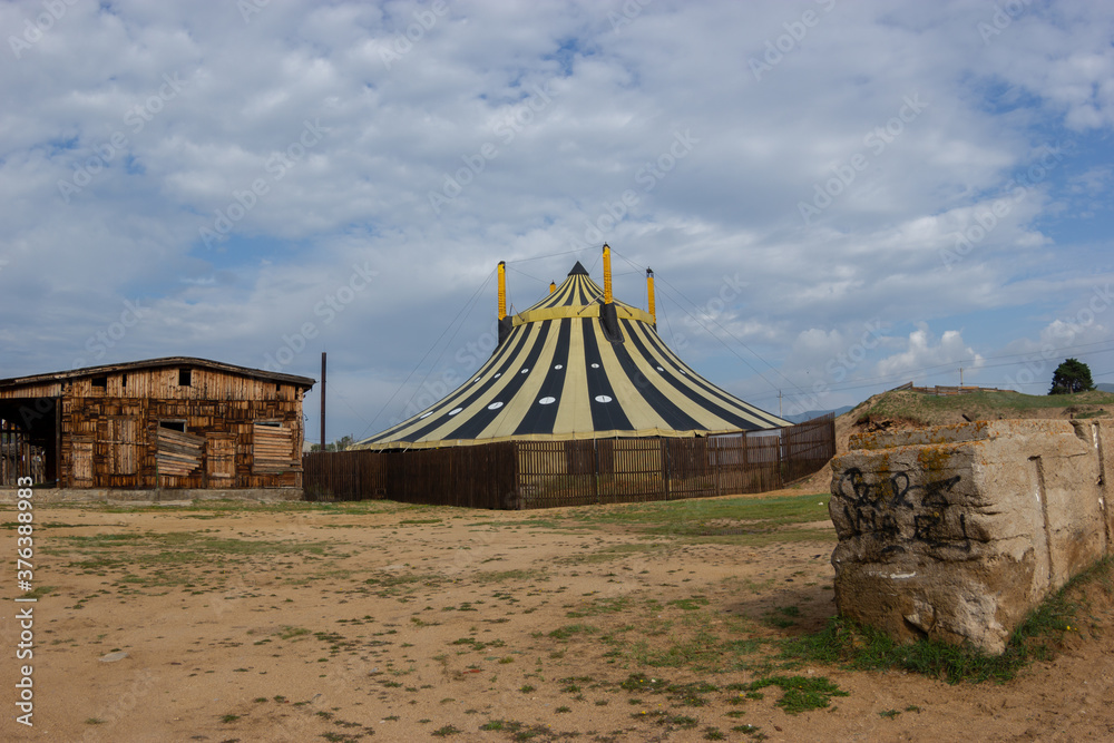 The old dome of an abandoned circus next to the building of an old ...