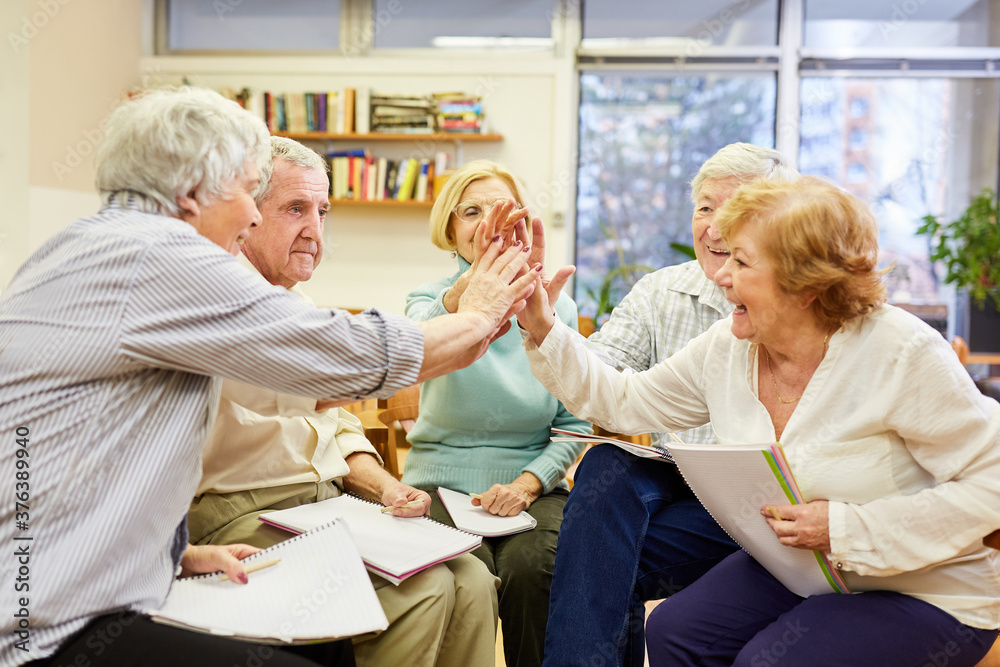 Seniors do high five in group therapy Stock Photo | Adobe Stock
