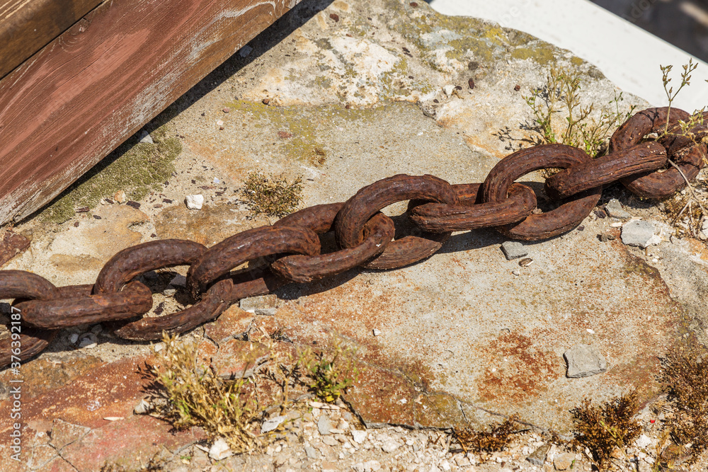 The old rusty metal chain of the anchor of the ship. Giant heavy steel ...