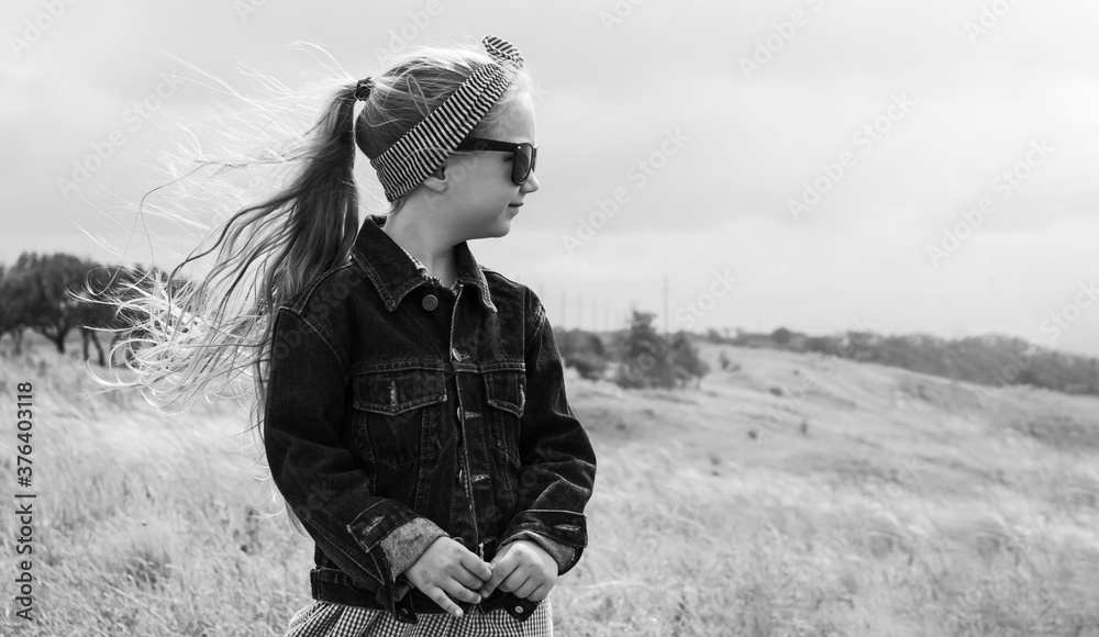 Adorable little girl in denim jacket, sunglasses, blue plaid dress in ...