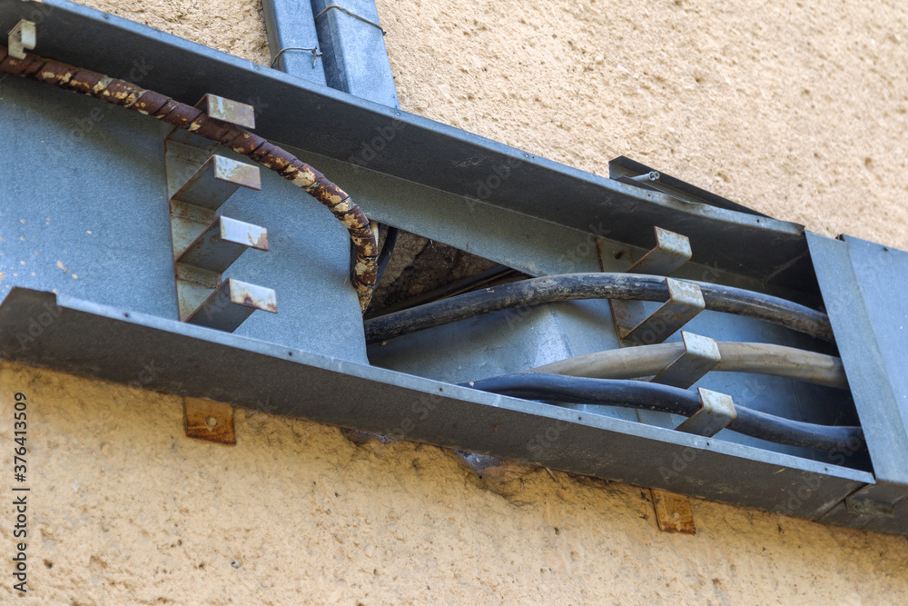 An antique vintage entry of electrical wires into the building. Putting ...