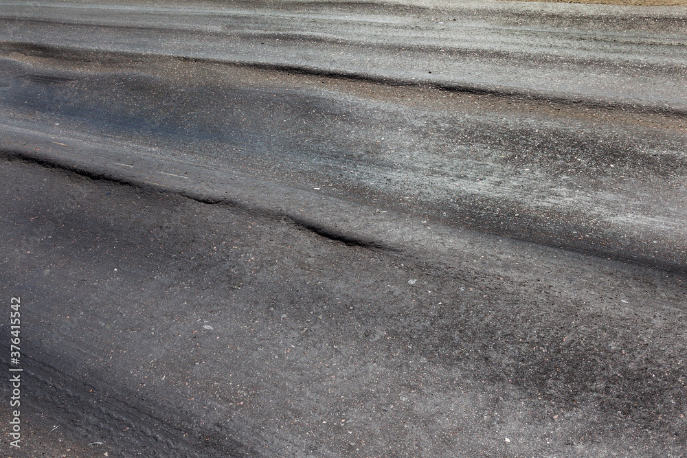 Damaged road, damaged chopped asphalt with potholes and spot. Very bad ...